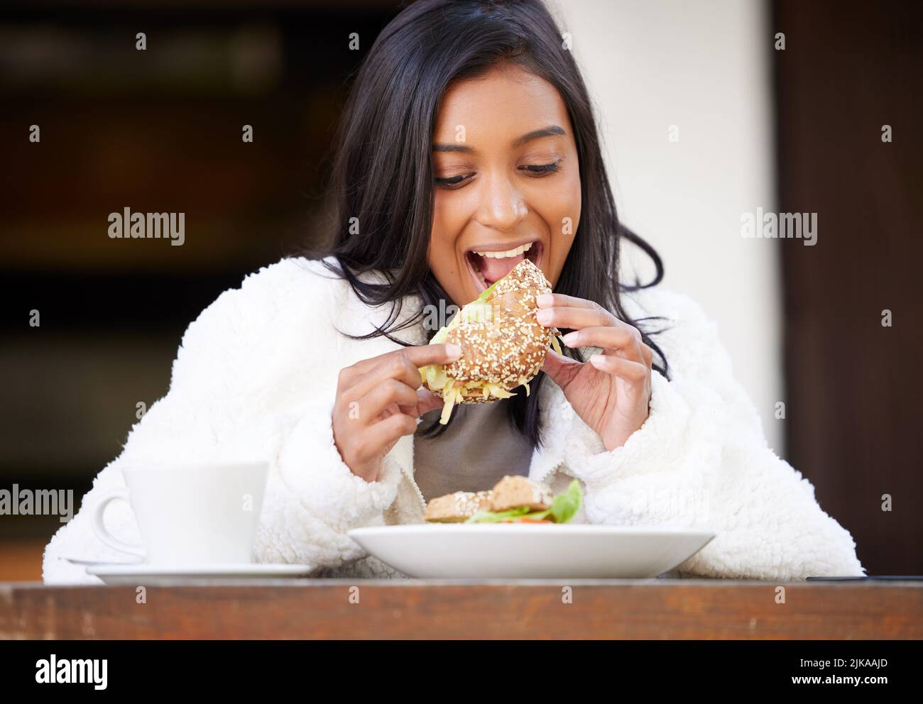 Lunchtime is the best part of my day. a young woman eating Stock Photo ...