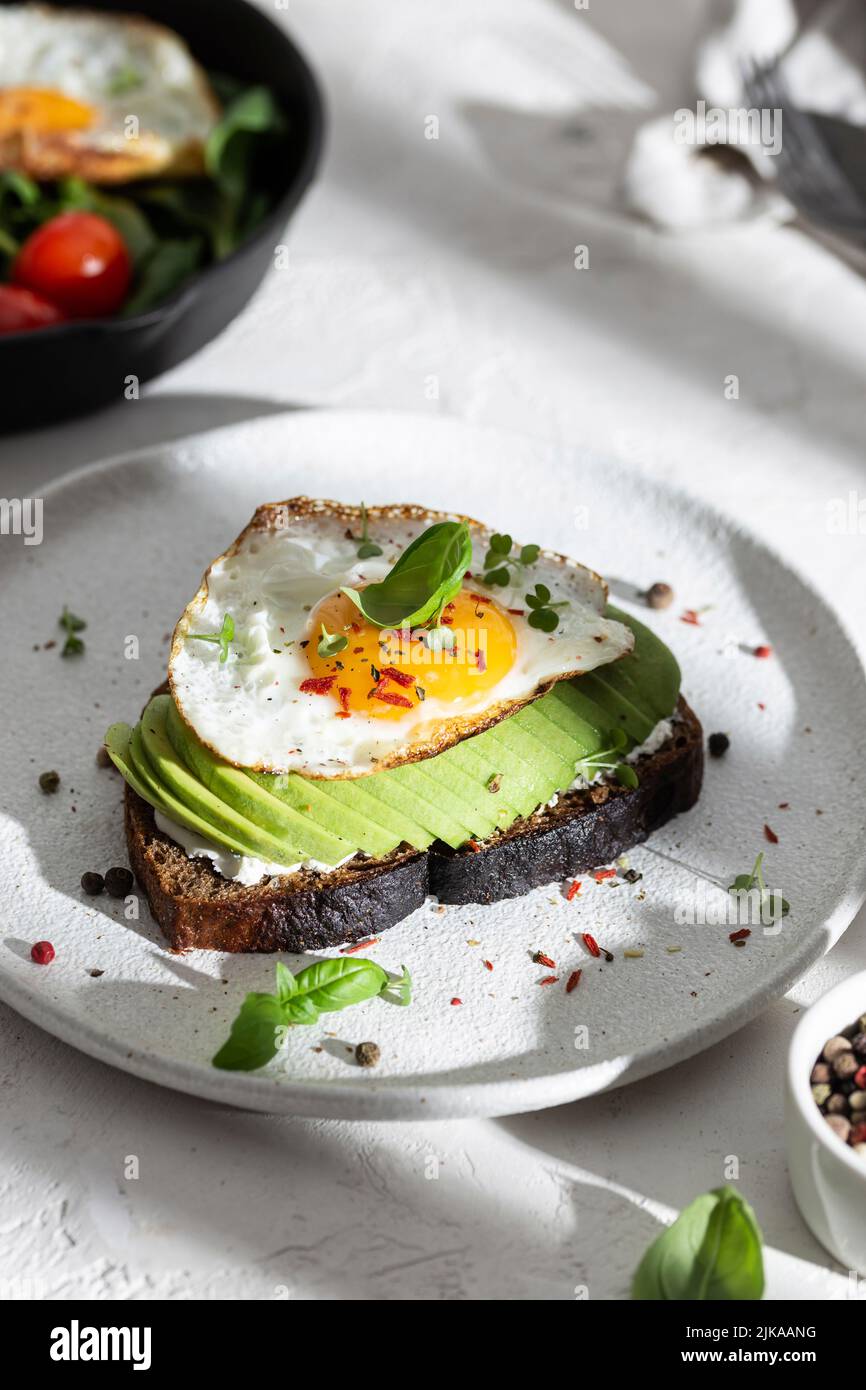Breakfast with toasted bread with avocado and grilled egg Stock Photo ...