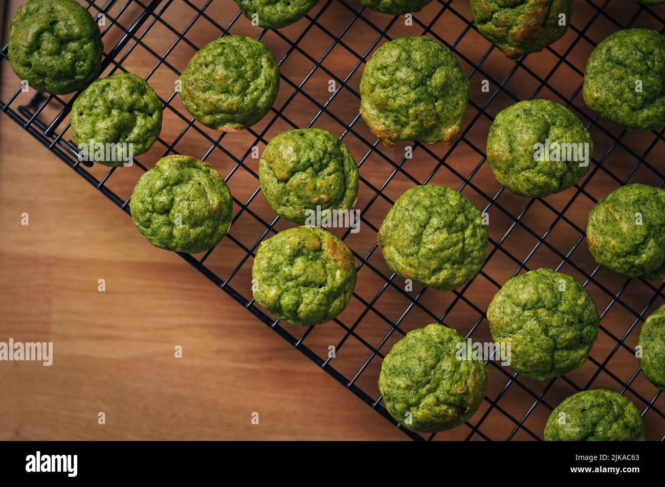 ready-made small green muffins with spinach on a baking sheet.healthy ...