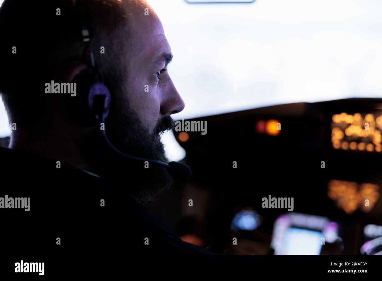 Plane captain looking through windscreen to fly aircraft, starting ...