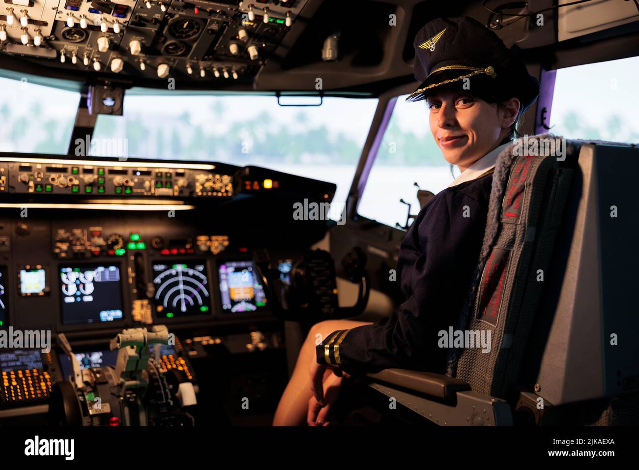Portrait of woman copilot in uniform flying airplane jet from cockpit ...
