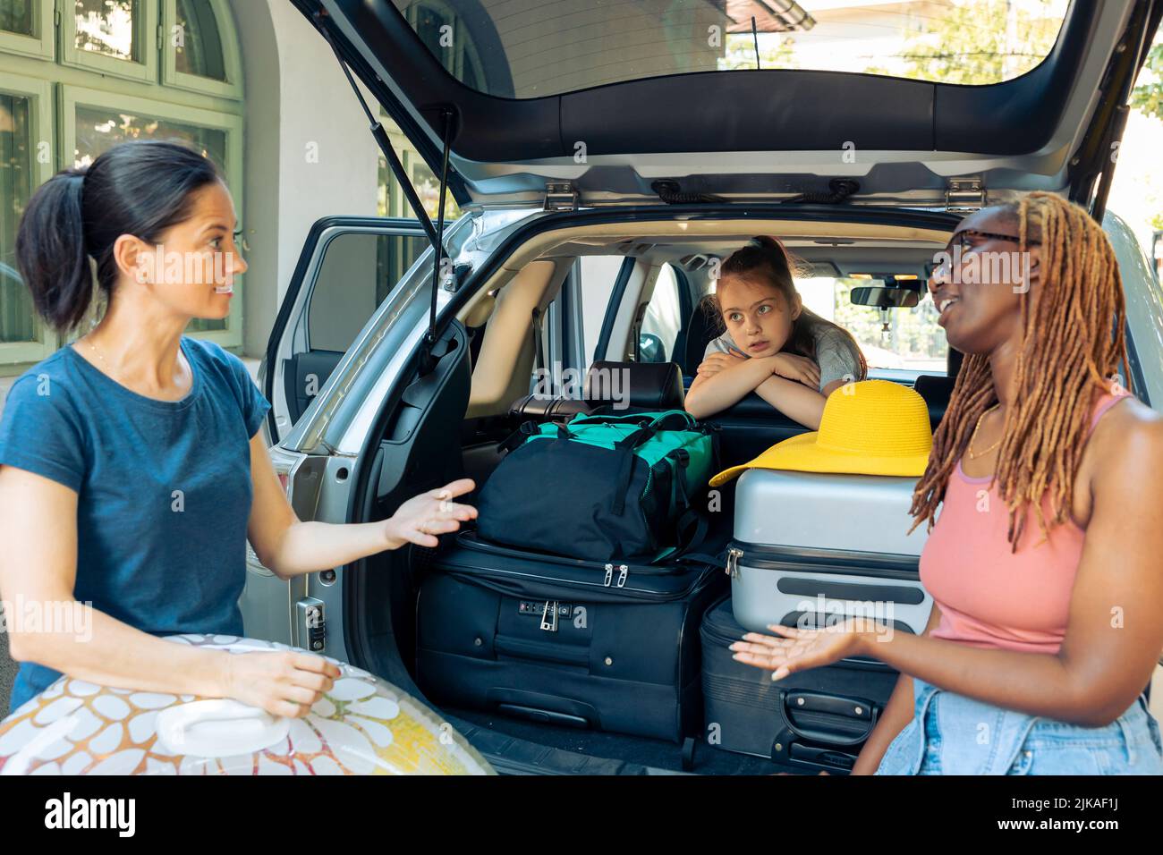 Diverse people travelling on vacation by car, leaving with family and ...