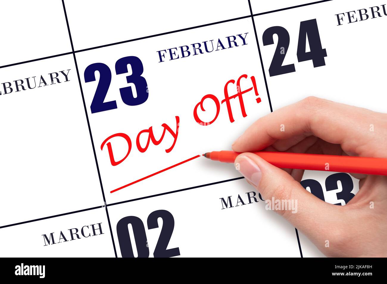 23rd day of February. Hand writing text DAY OFF and drawing a line on ...