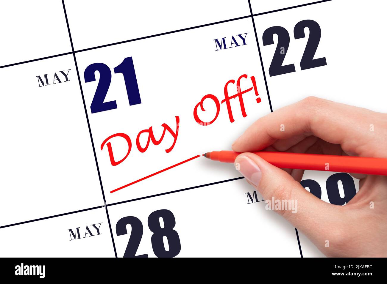21st day of May. Hand writing text DAY OFF and drawing a line on ...