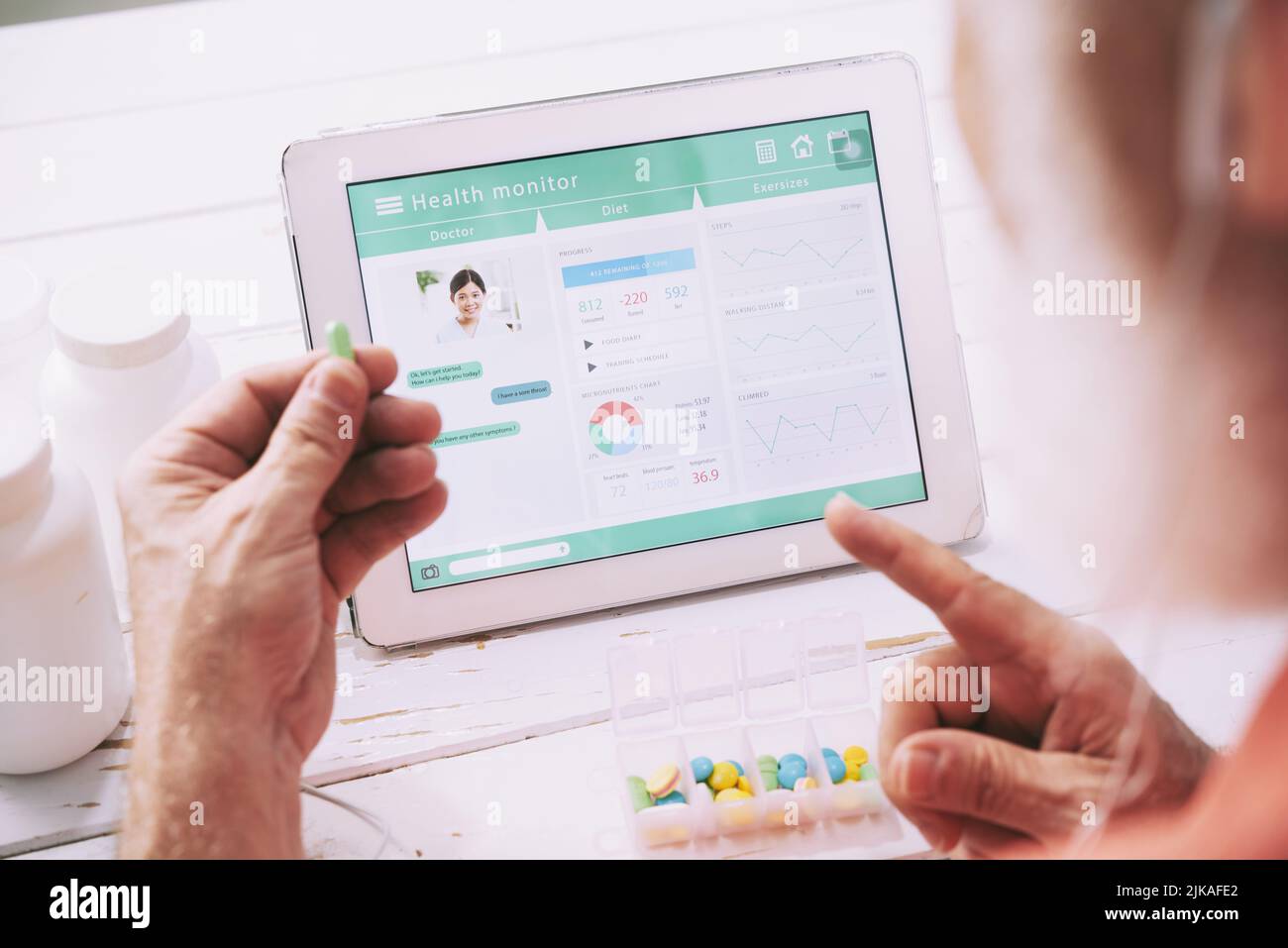 Elderly patient having online consultation with doctor on his tablet ...