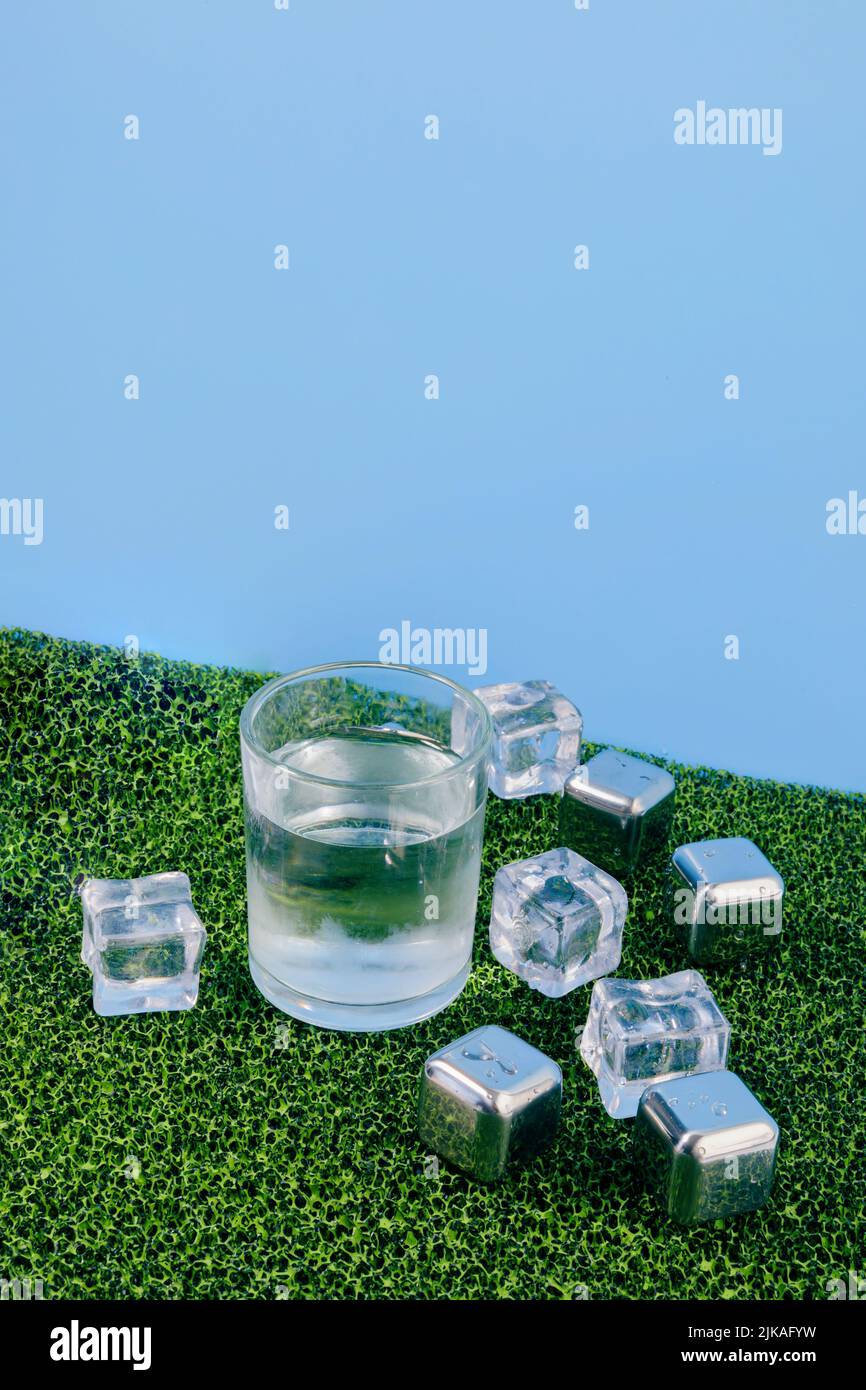 creative summer photo water cup and ice, blue background Stock Photo ...