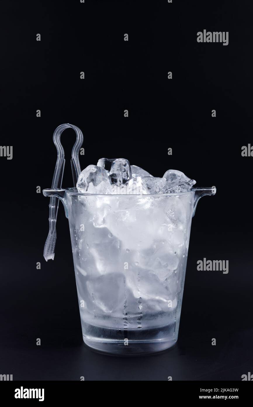 creative summer photo ice bucket in black background Stock Photo - Alamy