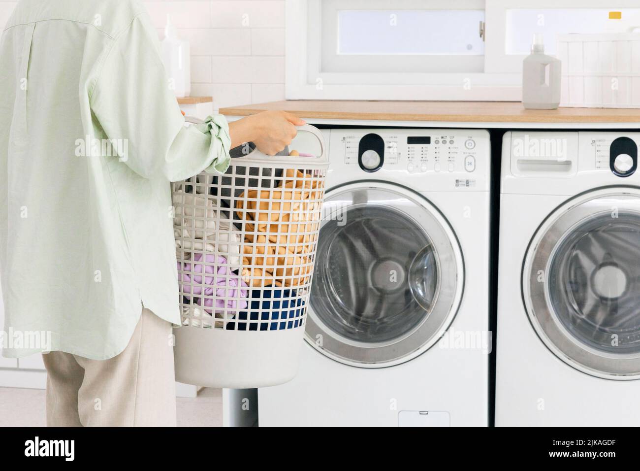 aesthetic laundry concept Putting laundry into the washing machine ...