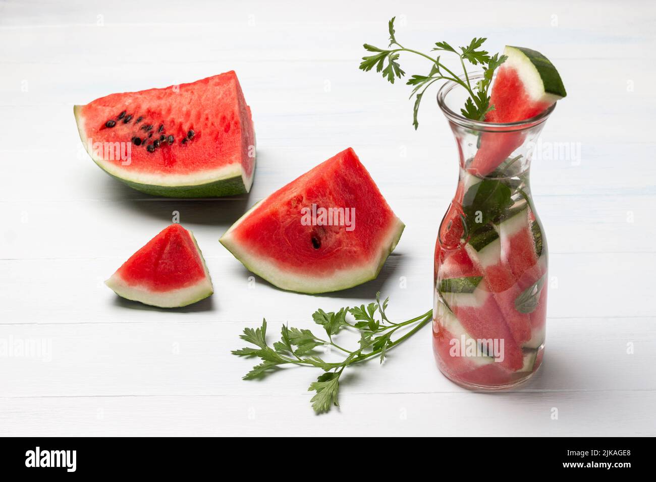 Homemade vitamin watermelon water with greens in glass jar. Piece of ...