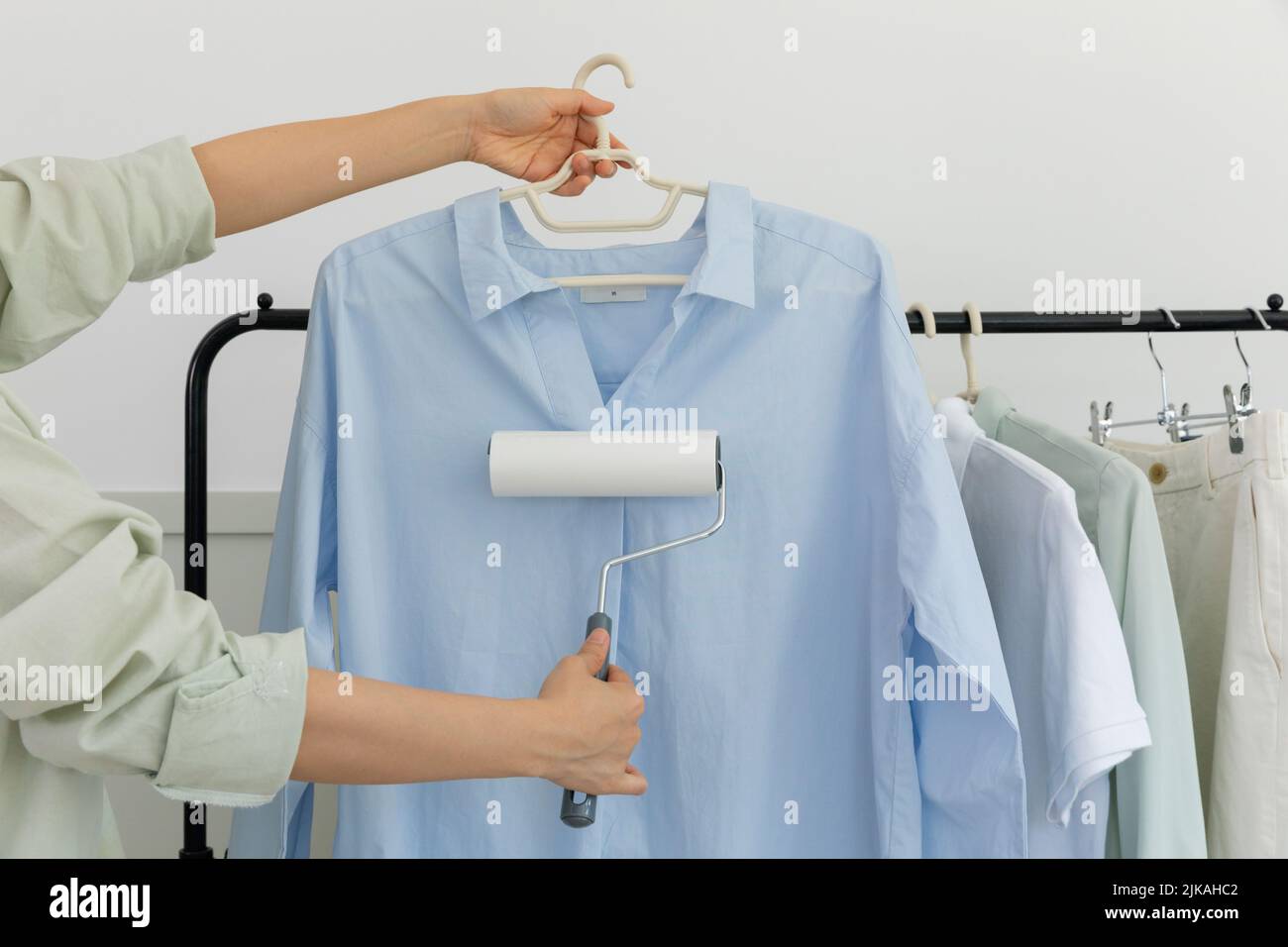 aesthetic laundry concept removing dust from clothes Stock Photo - Alamy