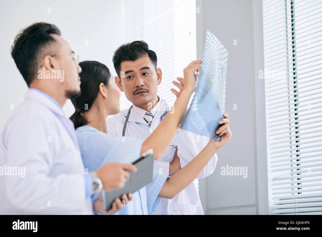 Team of Vietnamese doctors discussing x-ray of the patient Stock Photo ...