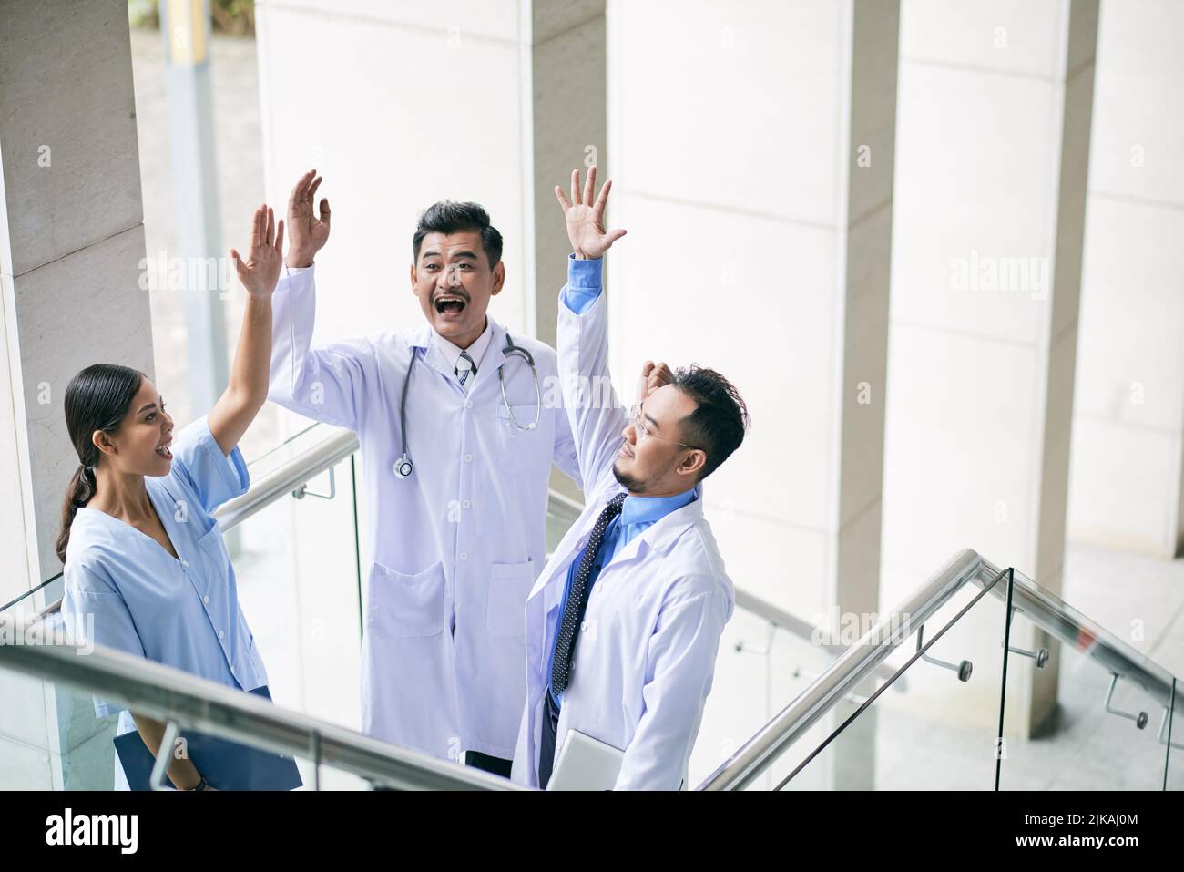 Excited happy Vietnamese medical workers raising hands Stock Photo - Alamy