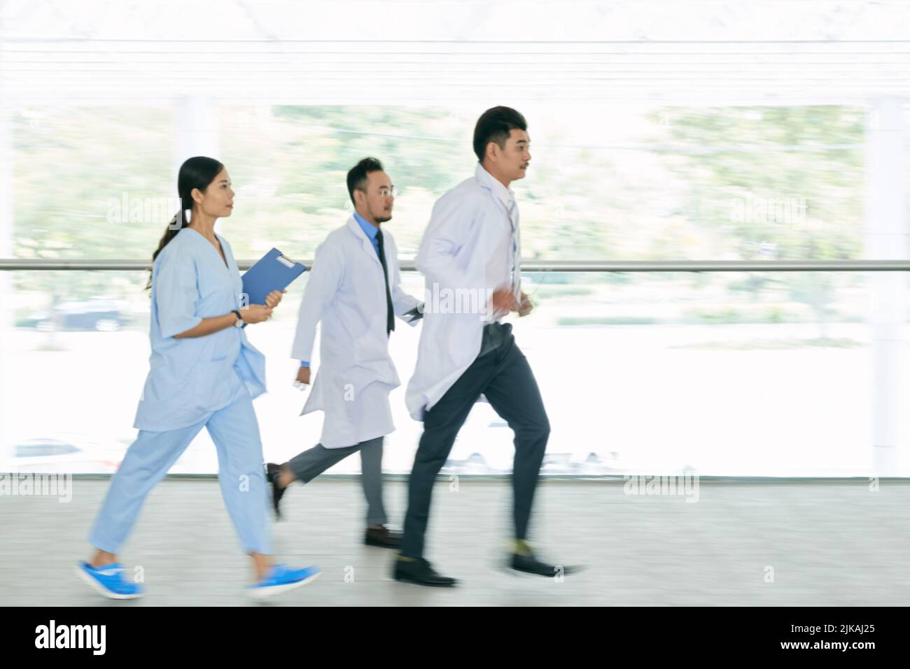 Doctors and nurse running to the patient, blurred motion Stock Photo ...