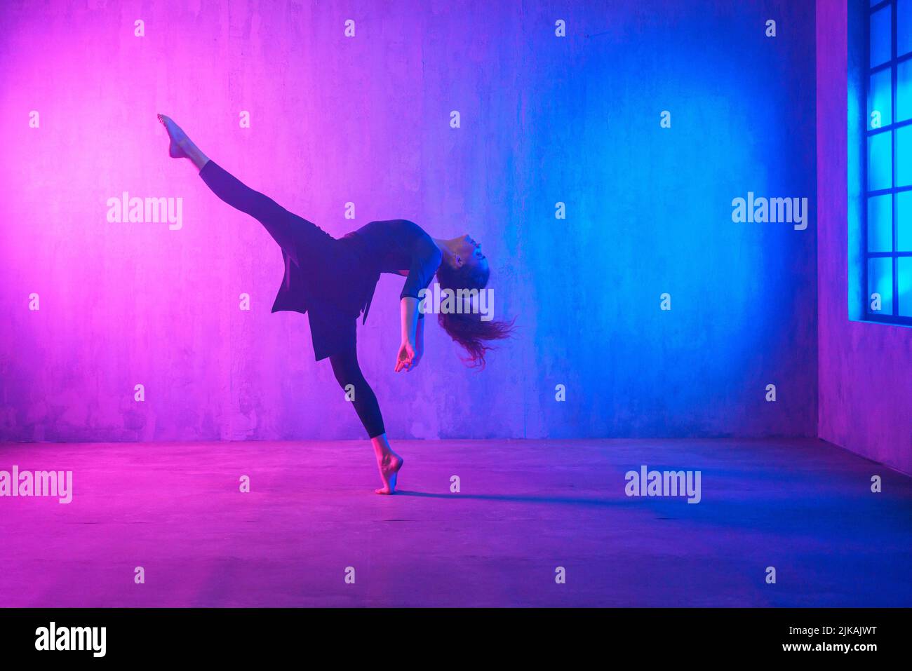 Modern dance girl dancer dancing in neon light doing gymnastic ...