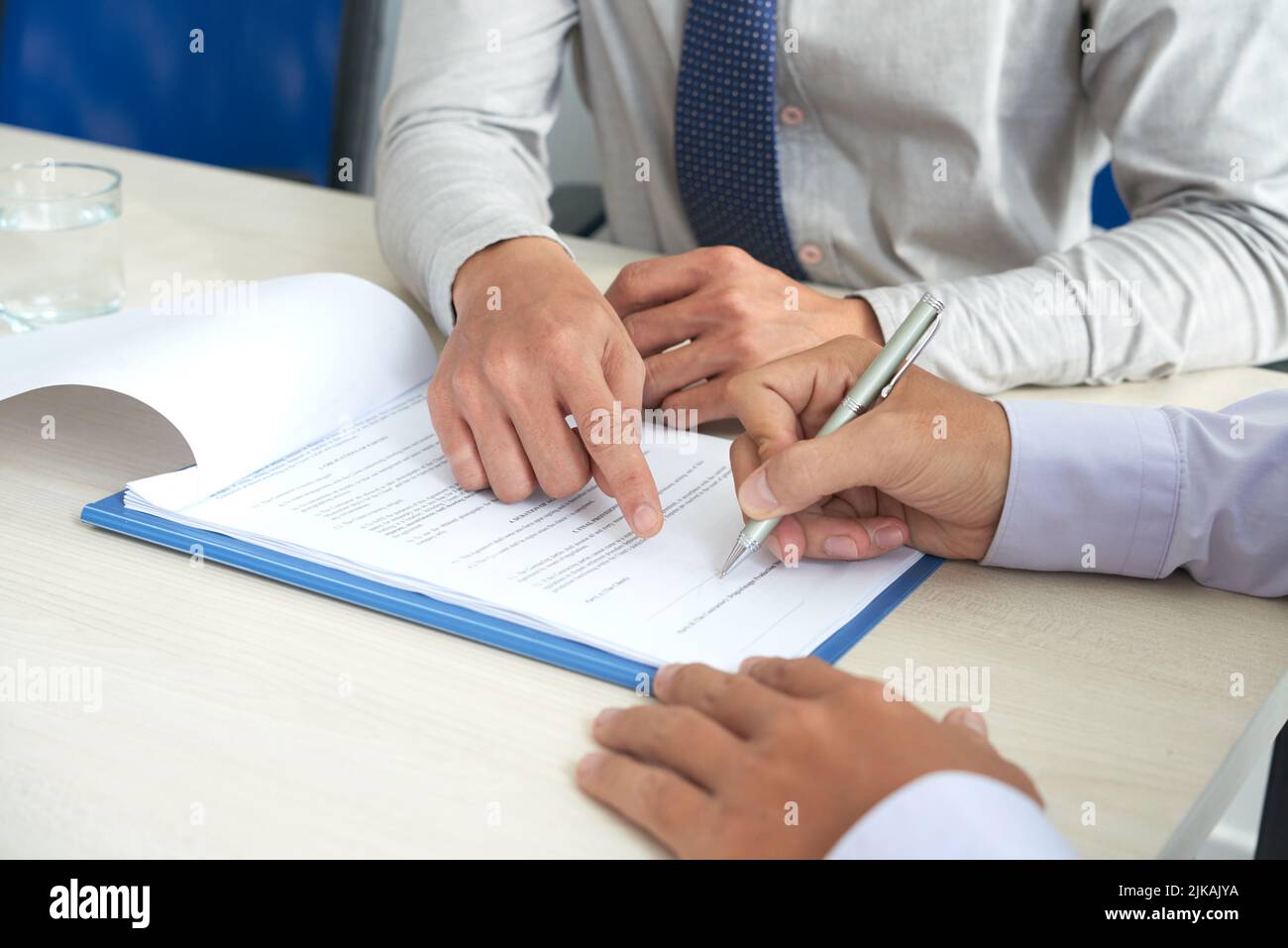Businessman showing his partner where to sign the contract Stock Photo ...