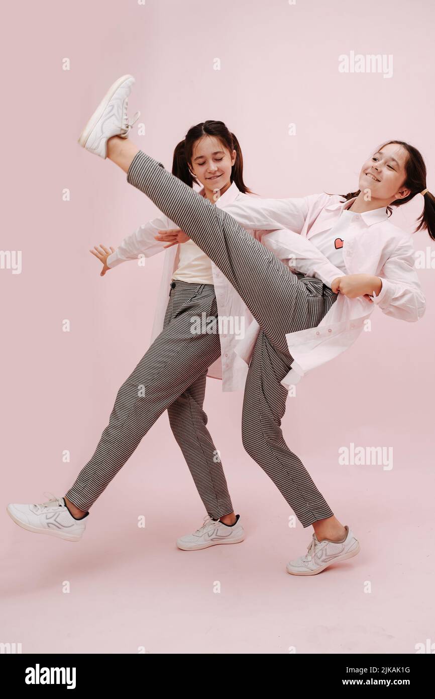 Cute and funny twin girls playing. bending back and trying to hold ...