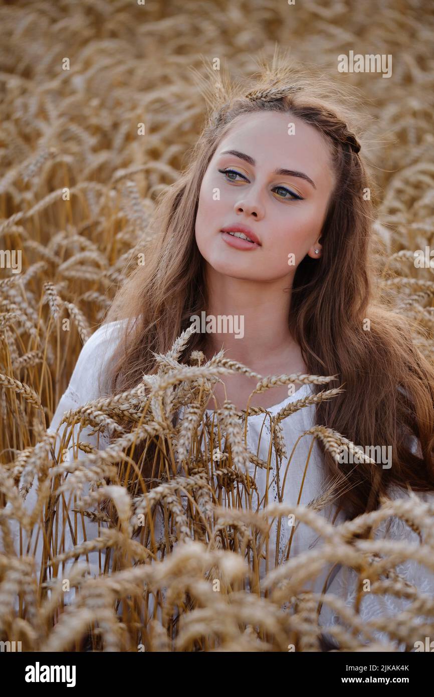 Beautiful woman on wheat field. Young female with makeup beauty ...