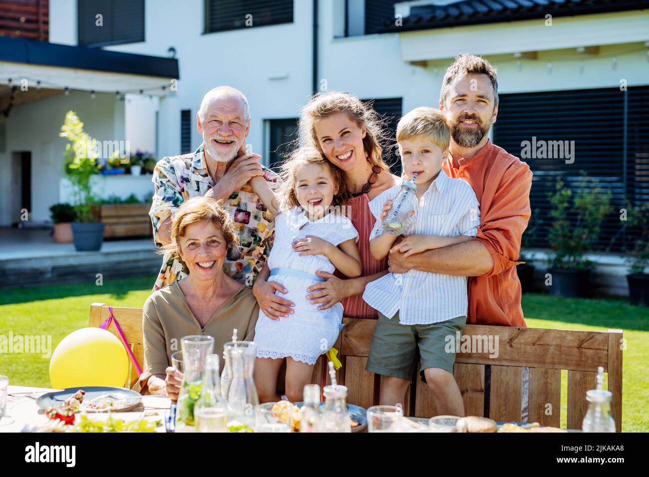 Multi generation family posing, taking photo on backyard in summer ...