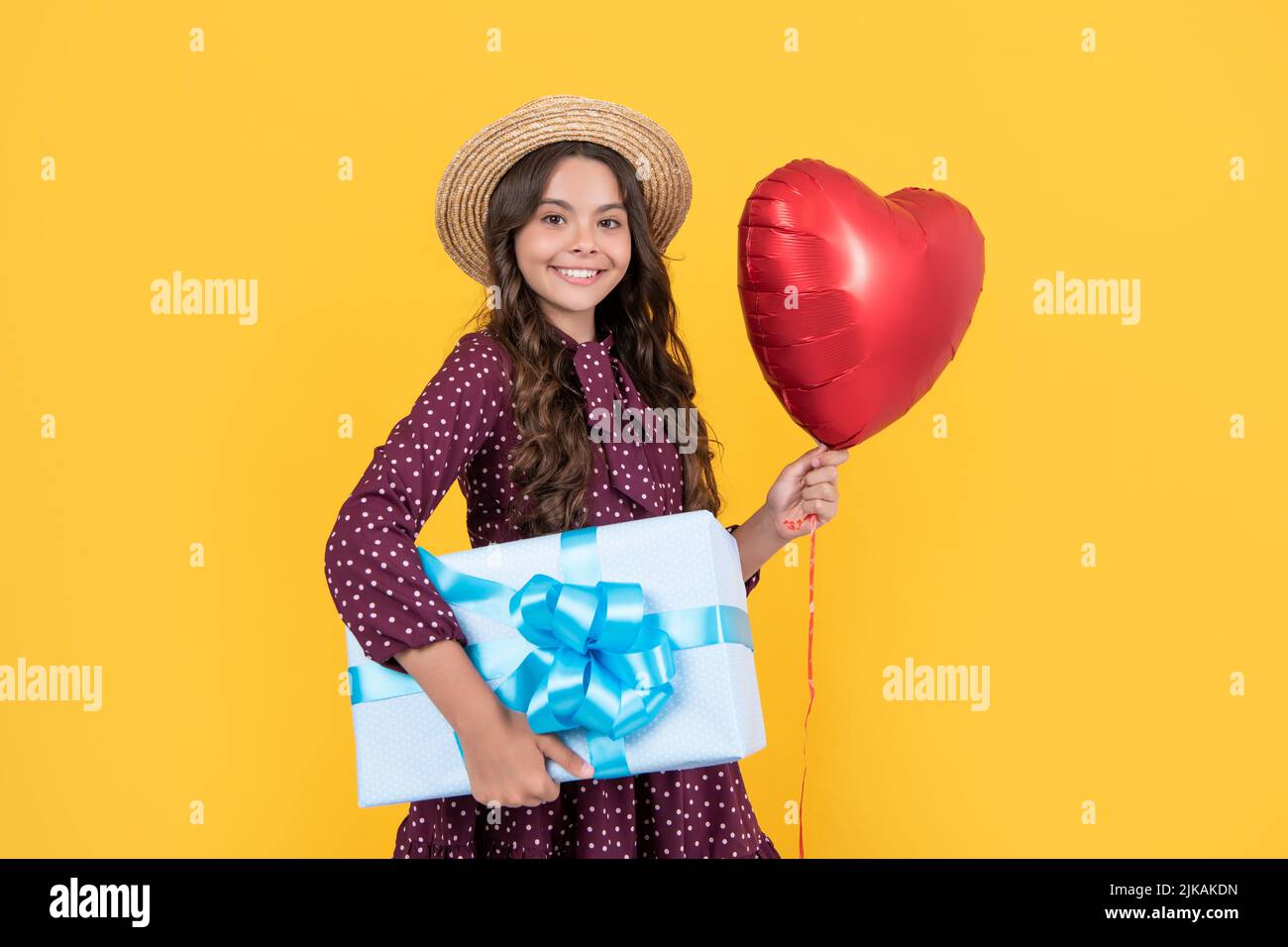 teen girl smile with red heart balloon and present box on yellow ...