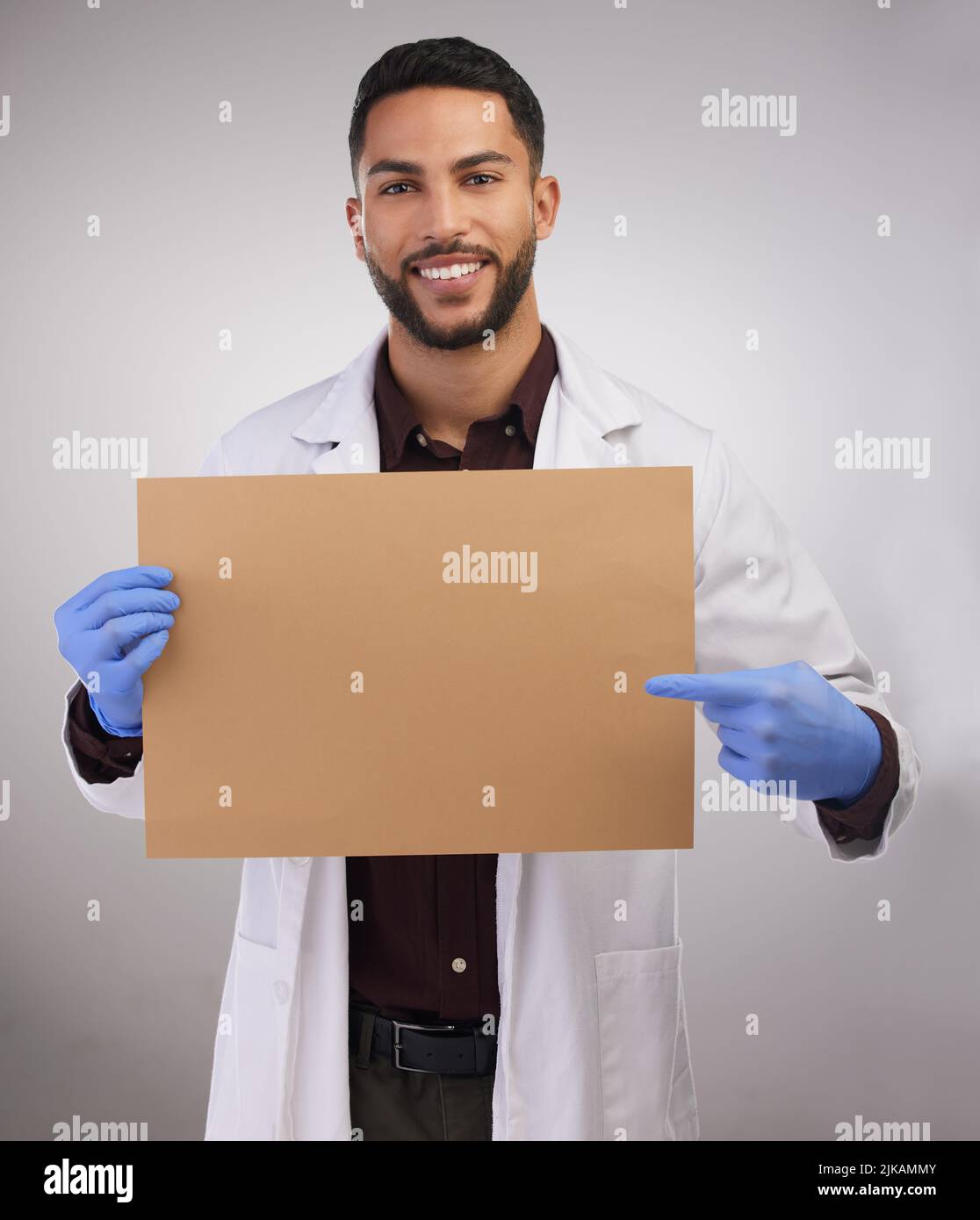 Go and check this out. a handsome young doctor standing alone in the ...