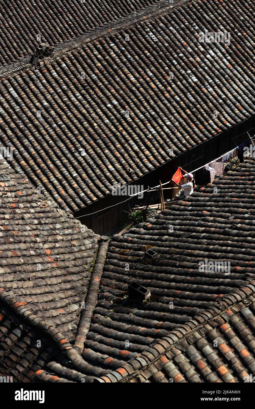 CHONGQING, CHINA - JULY 26, 2022 - A villager dries clothes at Xiaozhai ...