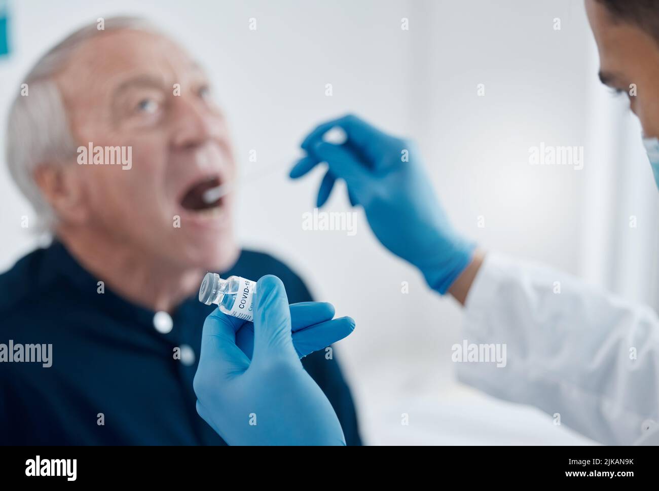 Just a quick mouth swab. an unrecognizable doctor testing a senior male ...