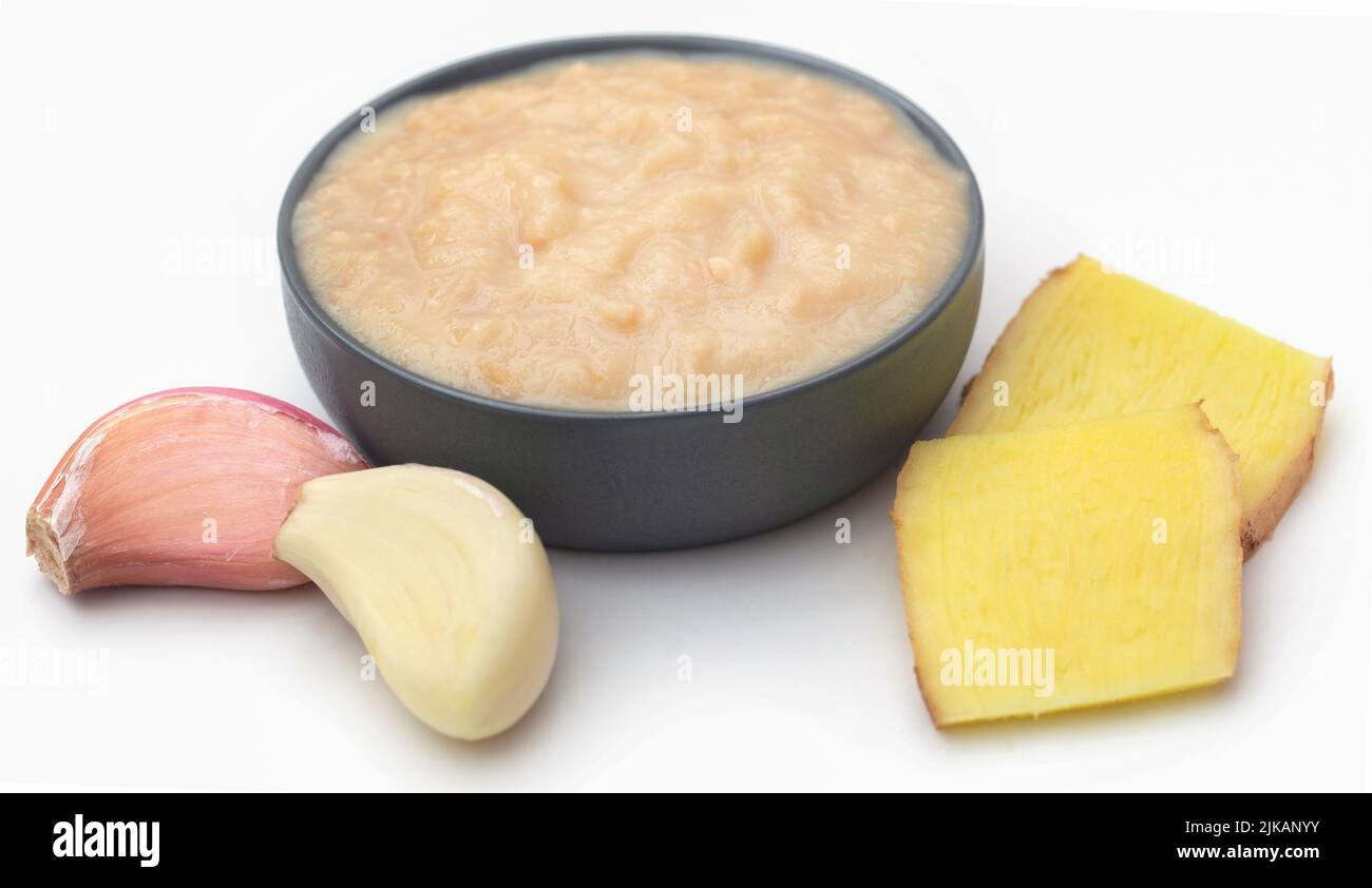 Ginger and garlic with paste over white background Stock Photo - Alamy