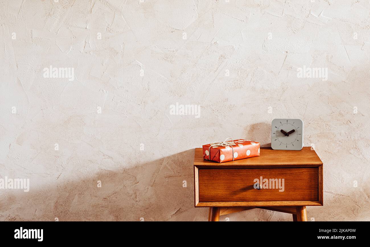 A bedside table with a gift box on it Stock Photo - Alamy