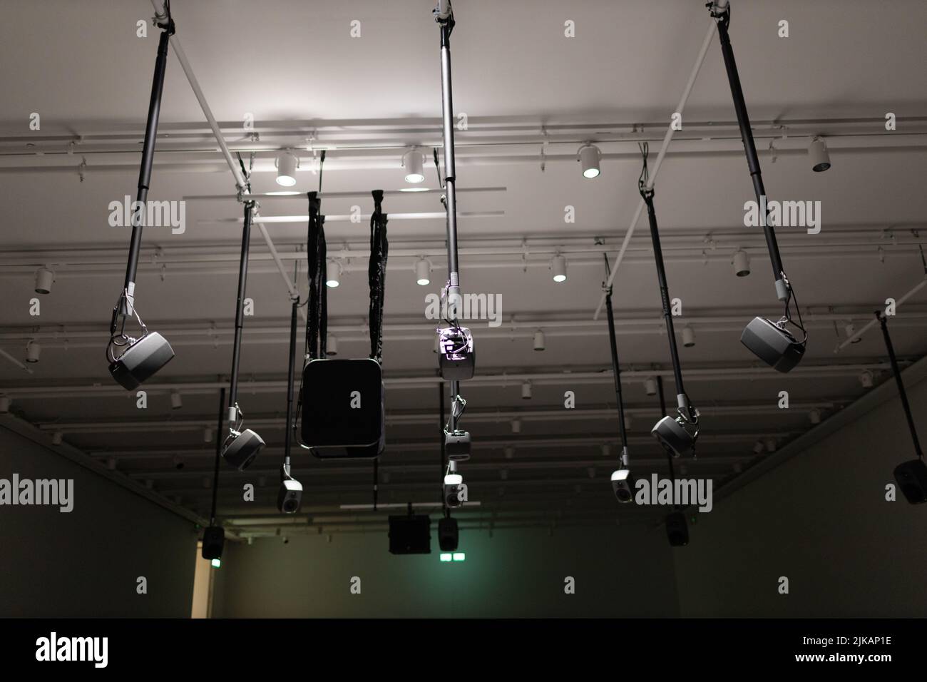 Young man listening to sound music surround installation with many ...