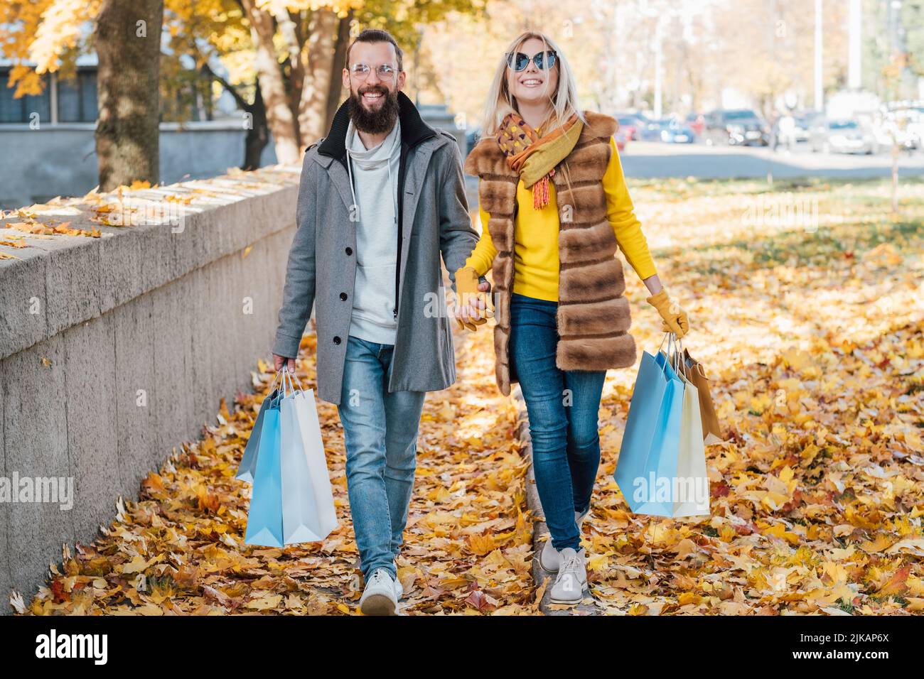 autumn fun couple shopping sidewalk leaves fall Stock Photo - Alamy