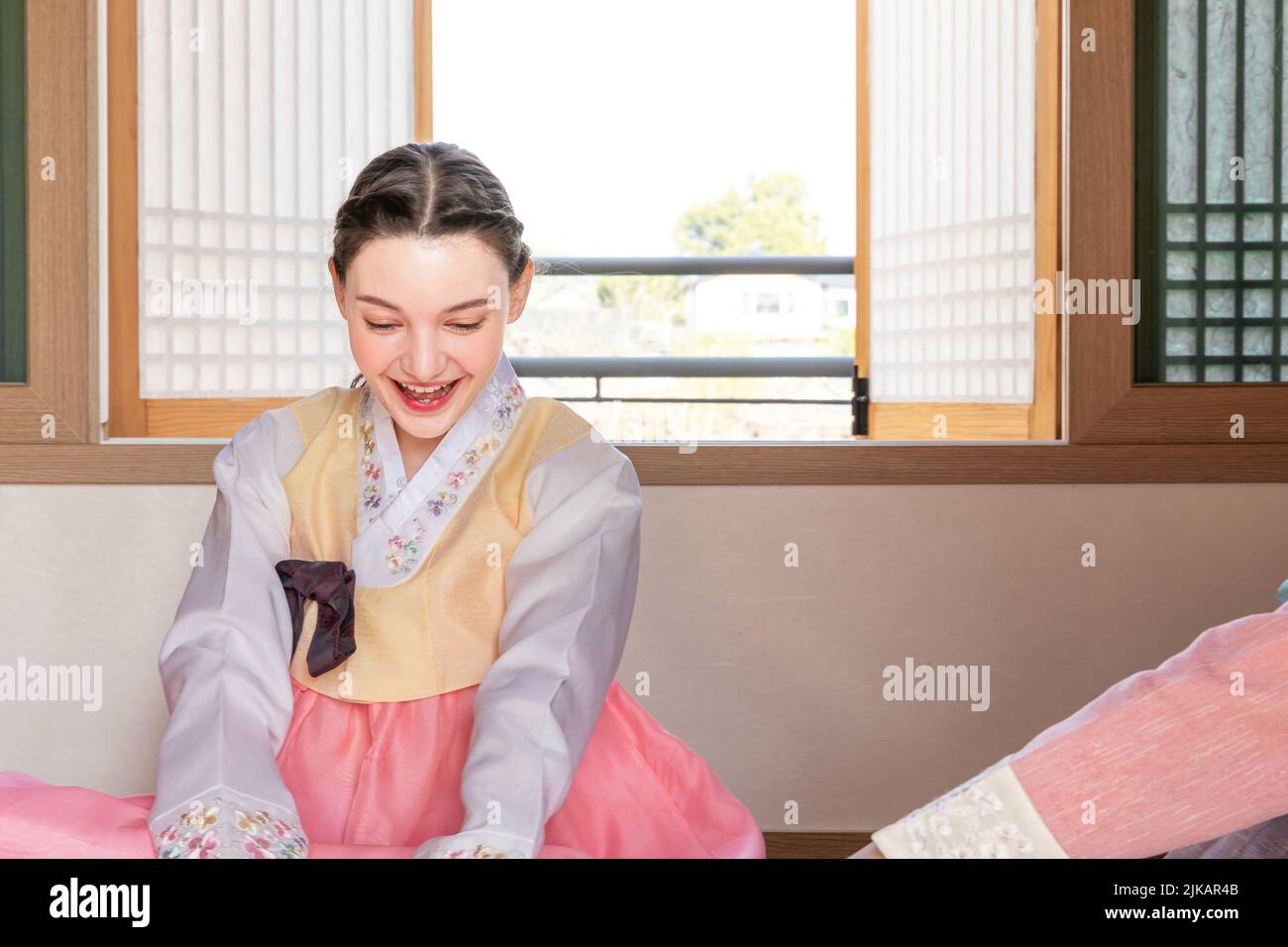 Korean and Caucasian girls wearing Hanbok playing Yut, Korean ...