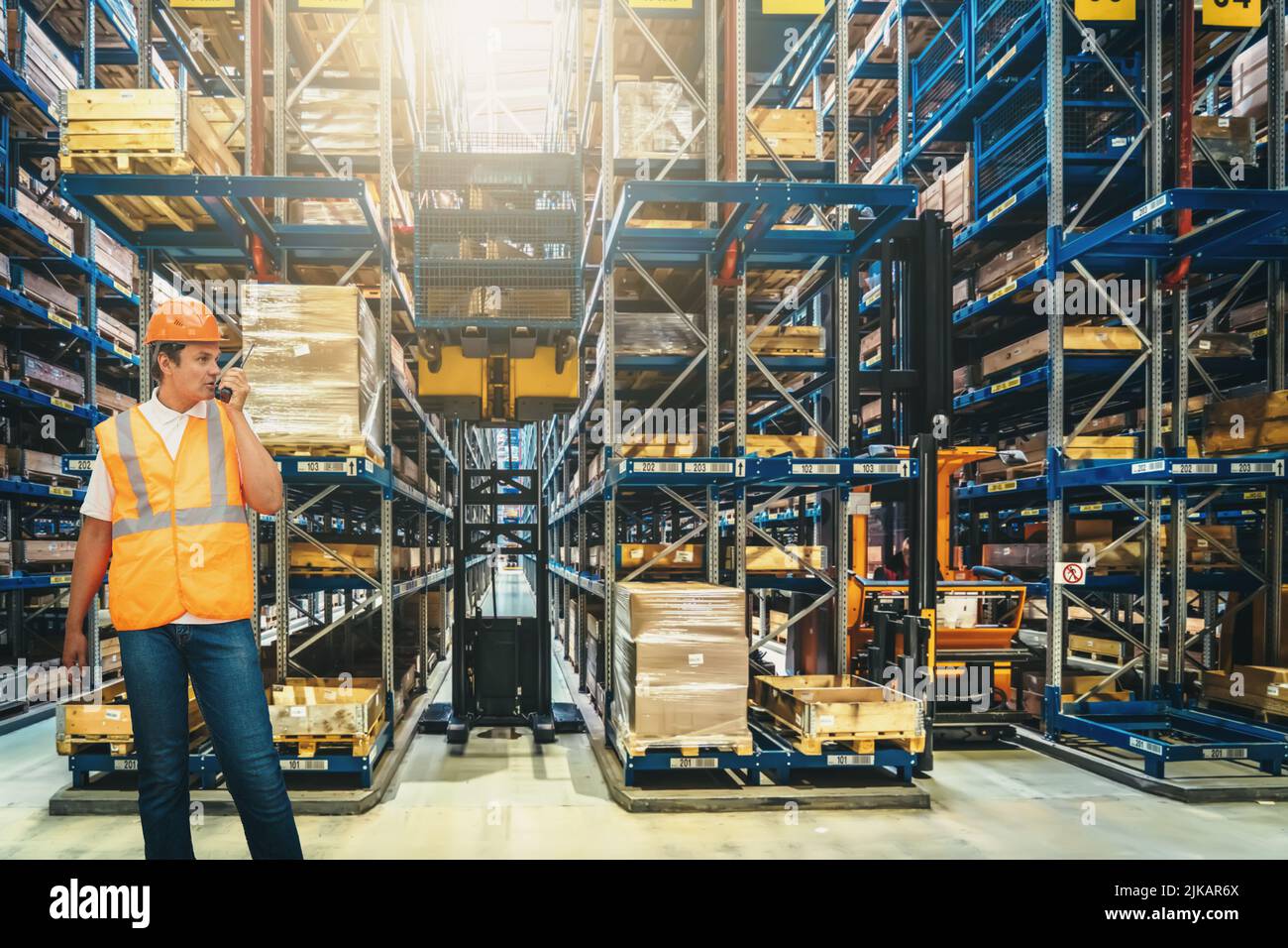 Logistic warehouse worker in helmet. Distribution warehouse with many ...