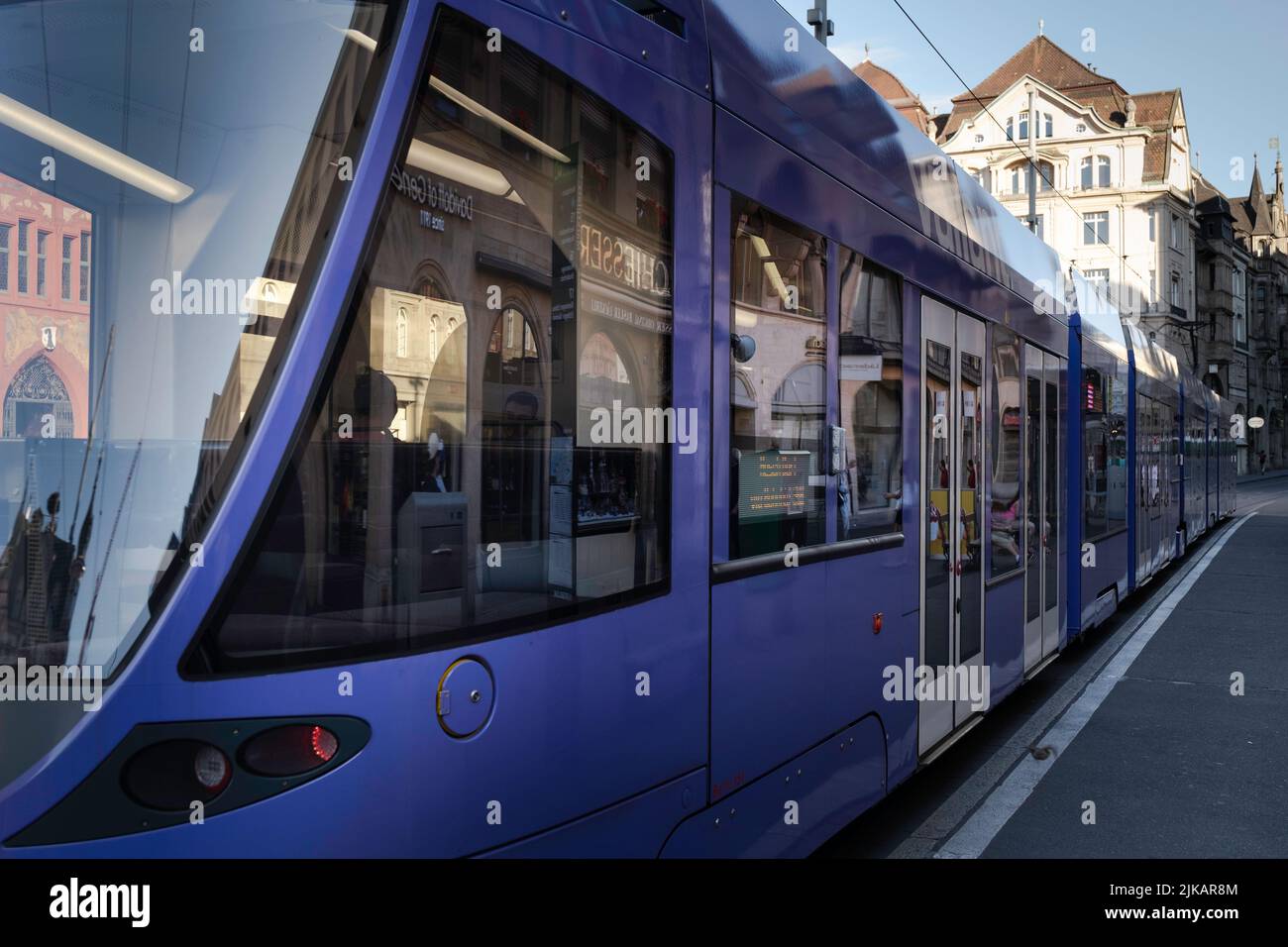 Side view of a blue electric tram with doors of the public transport ...