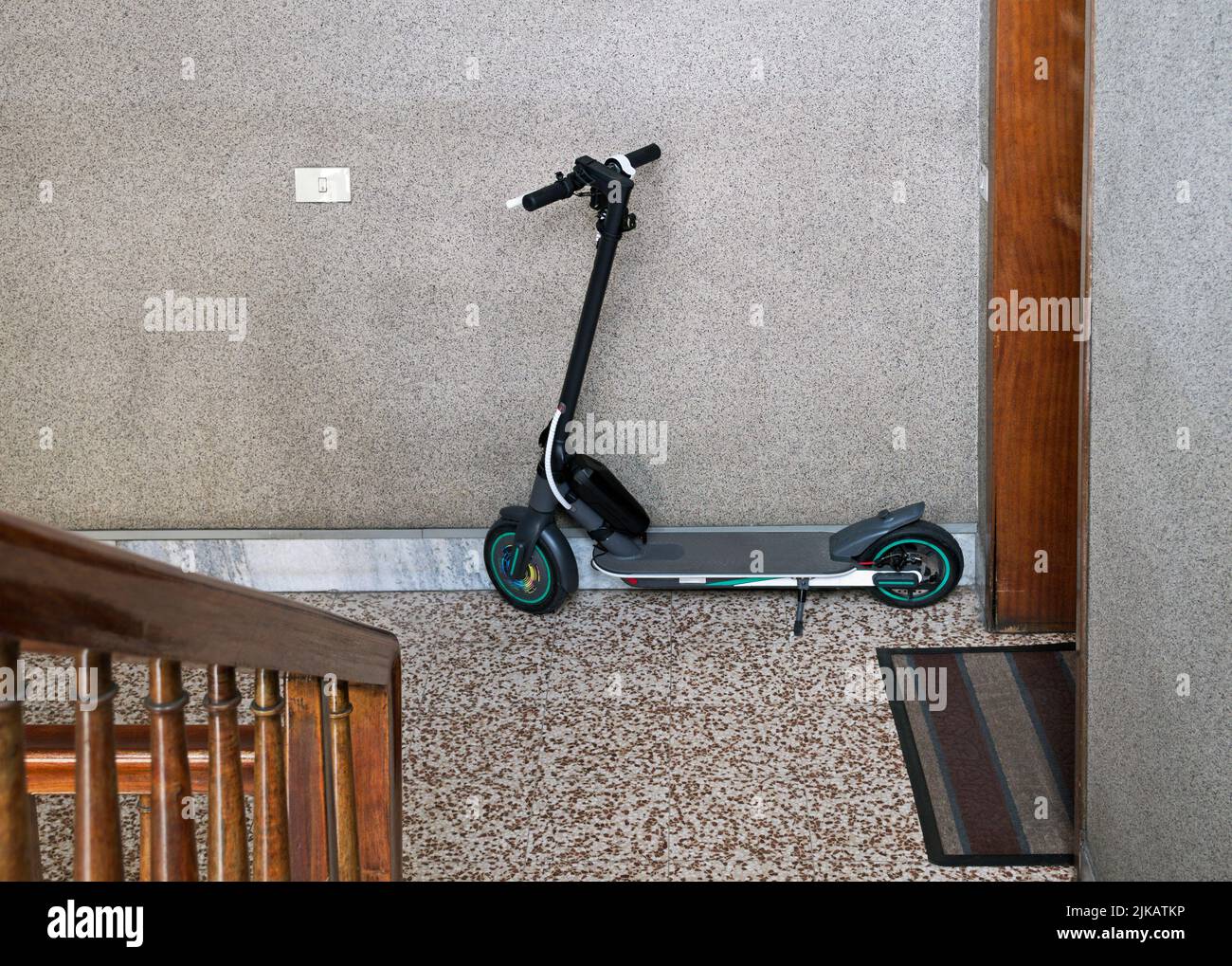 an electric scooter parked inside an apartment building Stock Photo - Alamy