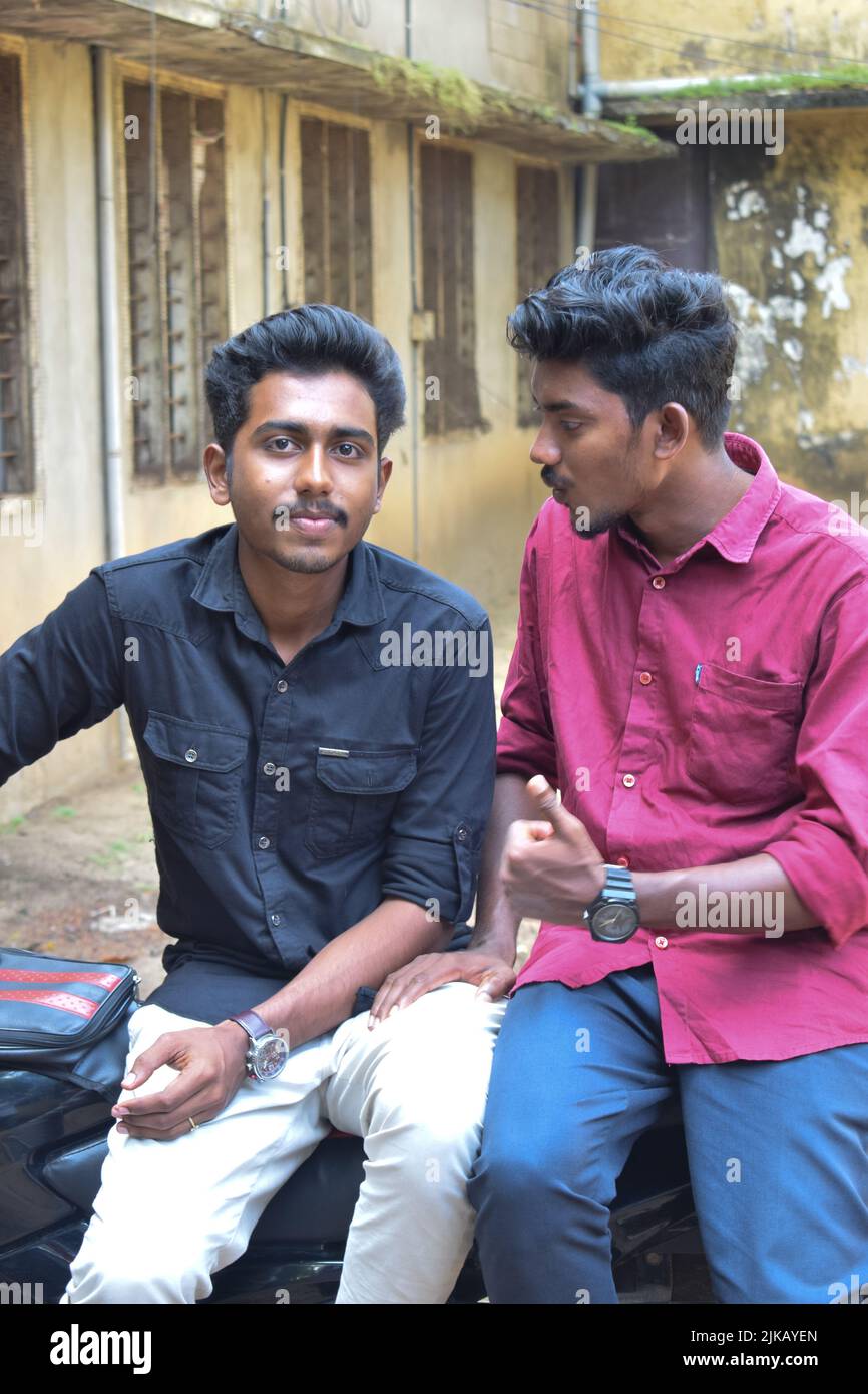 Indian young men posing for photo and smiling Stock Photo - Alamy