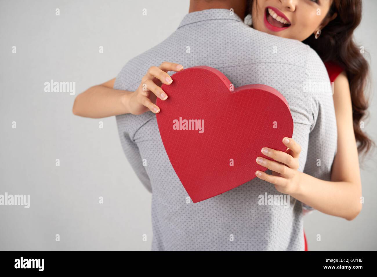 Young woman hugging gift box hi-res stock photography and images - Alamy