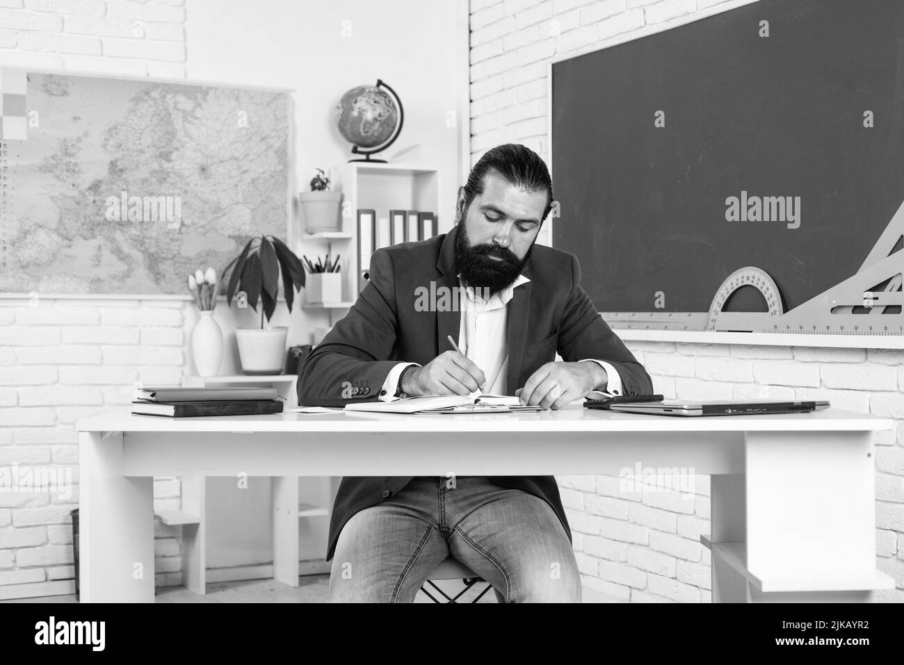 concentrated on work. male student sit in school classroom while lesson ...