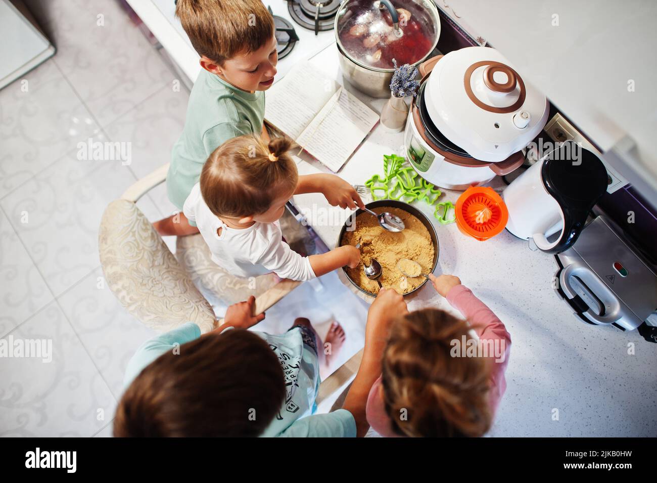 Kids cooking at kitchen, happy children's moments. They preparing ...