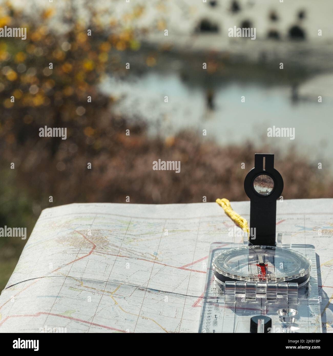 tourist essential tools compass map fall landscape Stock Photo - Alamy