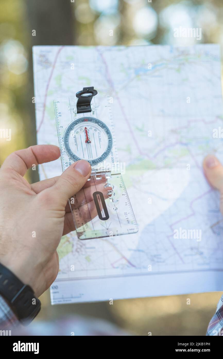 wanderlust adventures man compass map nature Stock Photo - Alamy