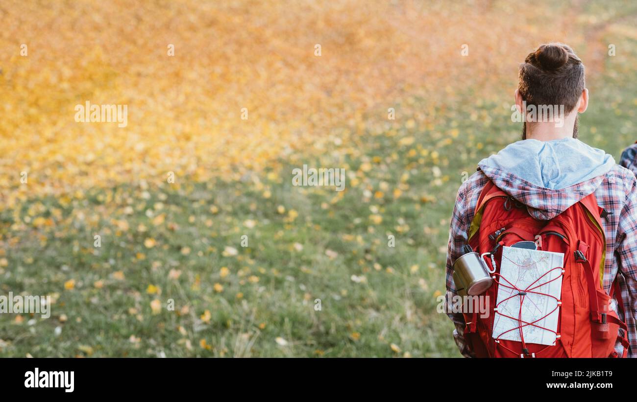traveler lifestyle man backpack fall meadow nature Stock Photo - Alamy