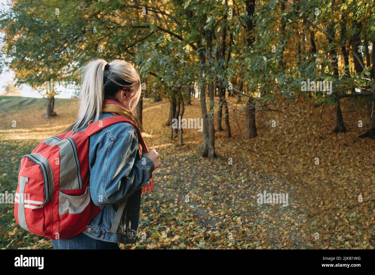 fall journey lady backpack autumn nature park Stock Photo - Alamy