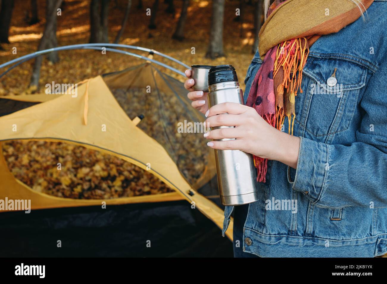 fall camping lady vacuum flask autumn nature park Stock Photo - Alamy