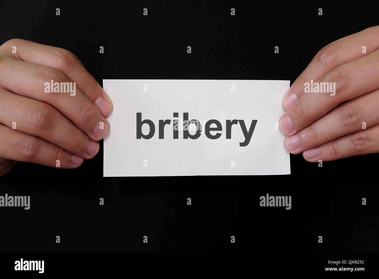 Bribery crime case mug shot concept. Criminal hands holding paper ...