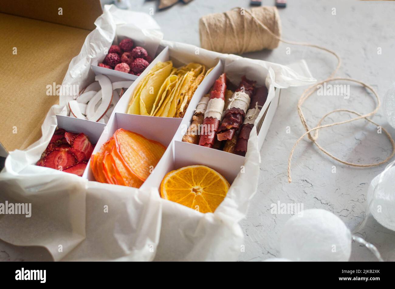 assorted handmade natural organic dried chips in box on grey background ...