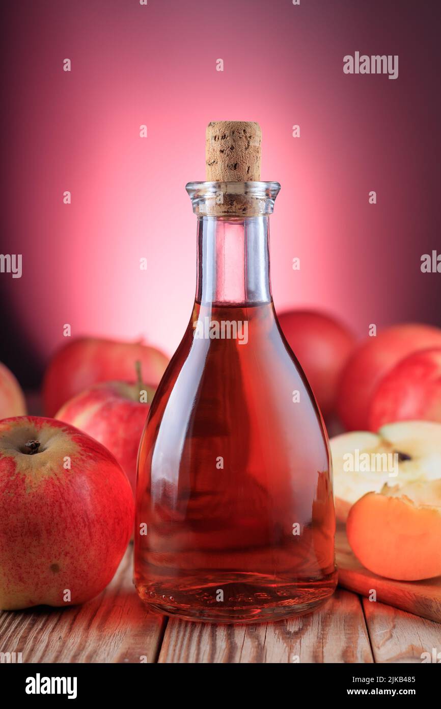 Bottle of apple cider and red apples on wooden background Stock Photo ...