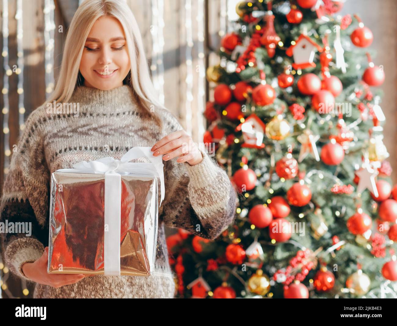 christmas surprise lady sweater gift box fir tree Stock Photo - Alamy