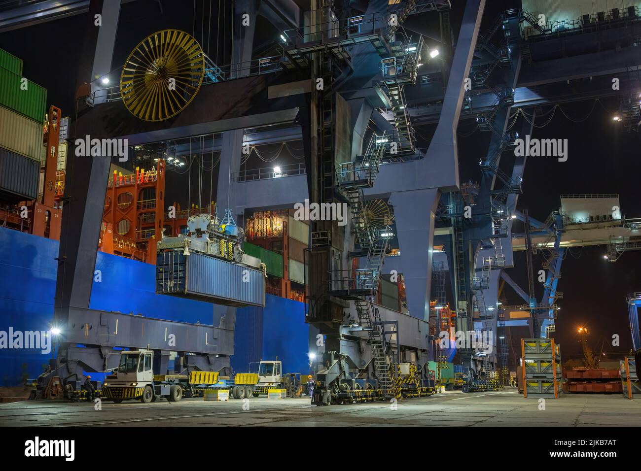 operation of container terminal at night. Unloading container ship at ...