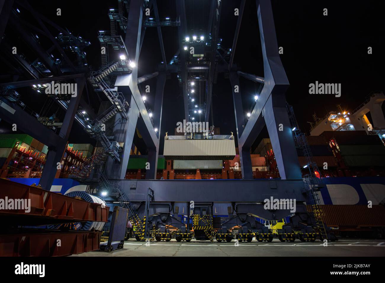 operation of container terminal at night. Unloading container ship at ...