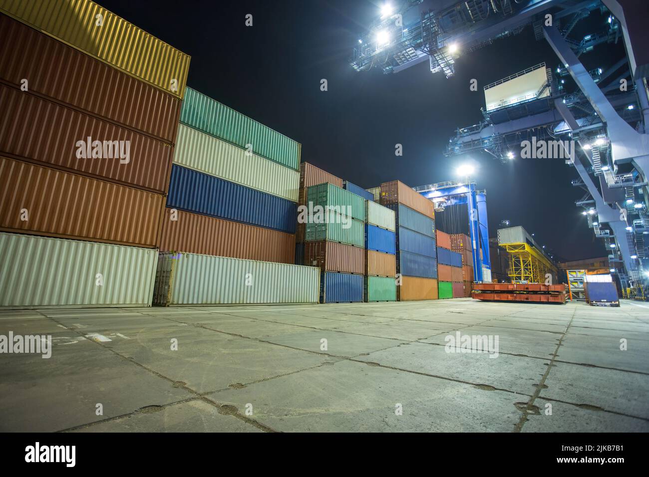 operation of container terminal at night. Unloading container ship at ...